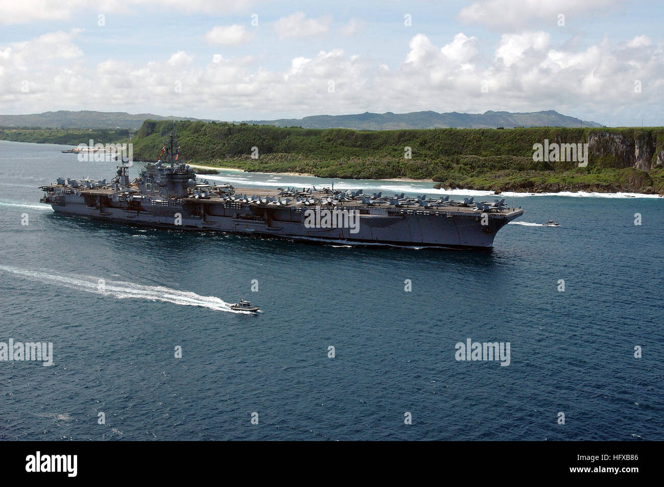 USS Kitty Hawk, a conventionally powered aircraft carrier, departs Apra ...