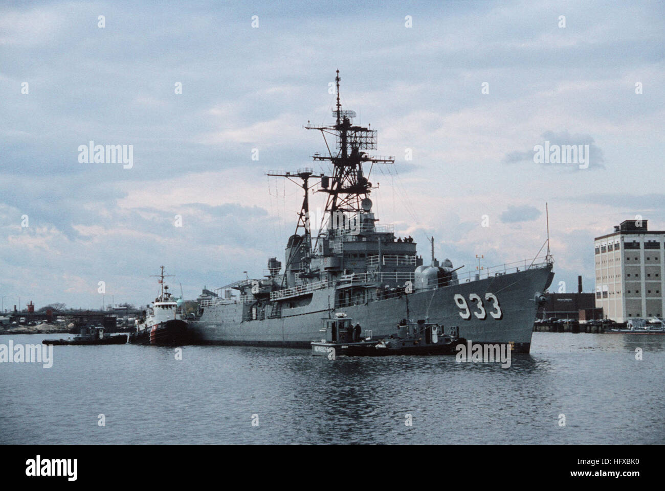 A starboard bow view of the destroyer USS BARRY (DD 933) being moved ...