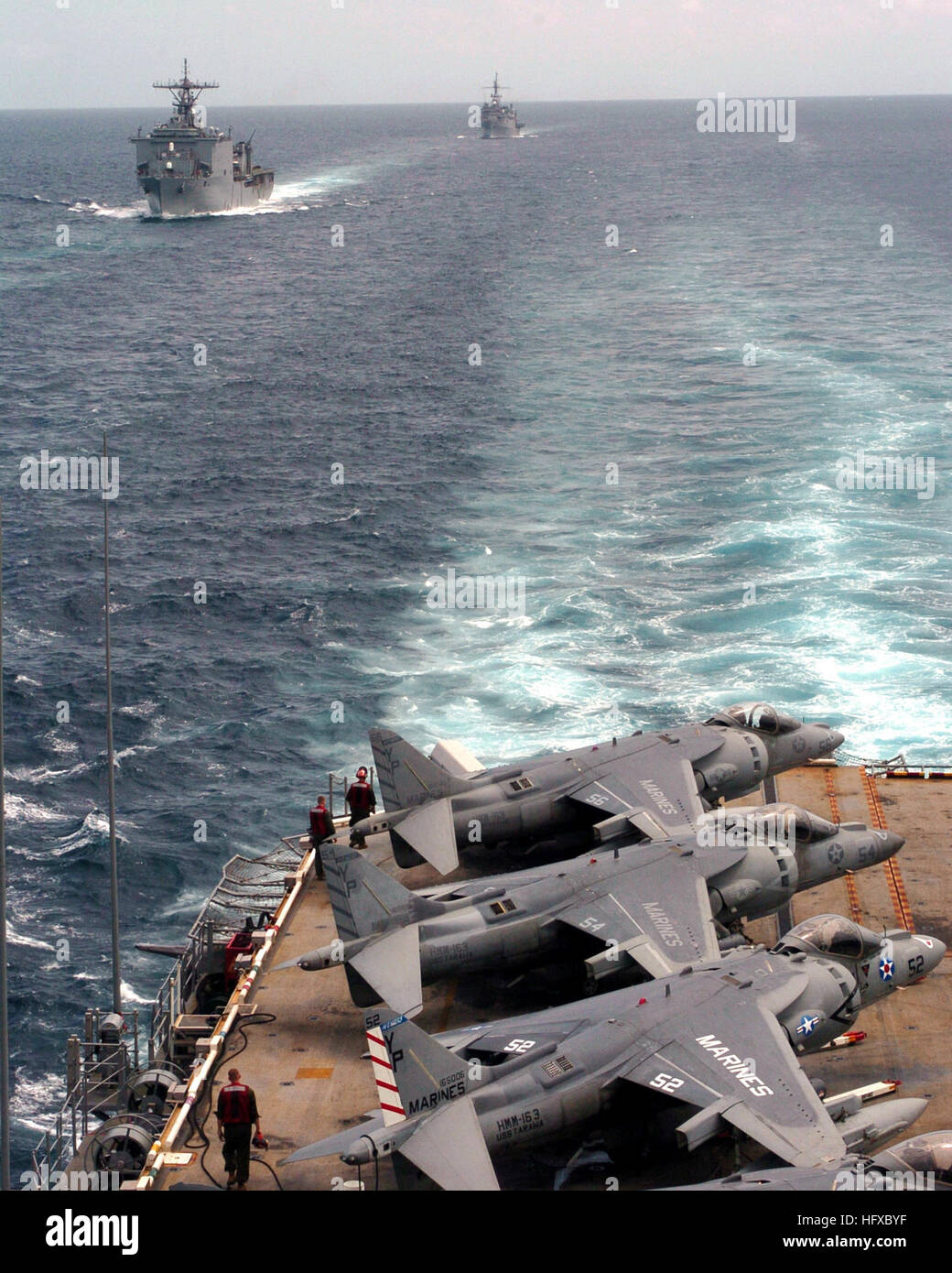 USS Pearl Harbor (LSD 52) and USS Cleveland (LPD 7) follow USS Tarawa ...