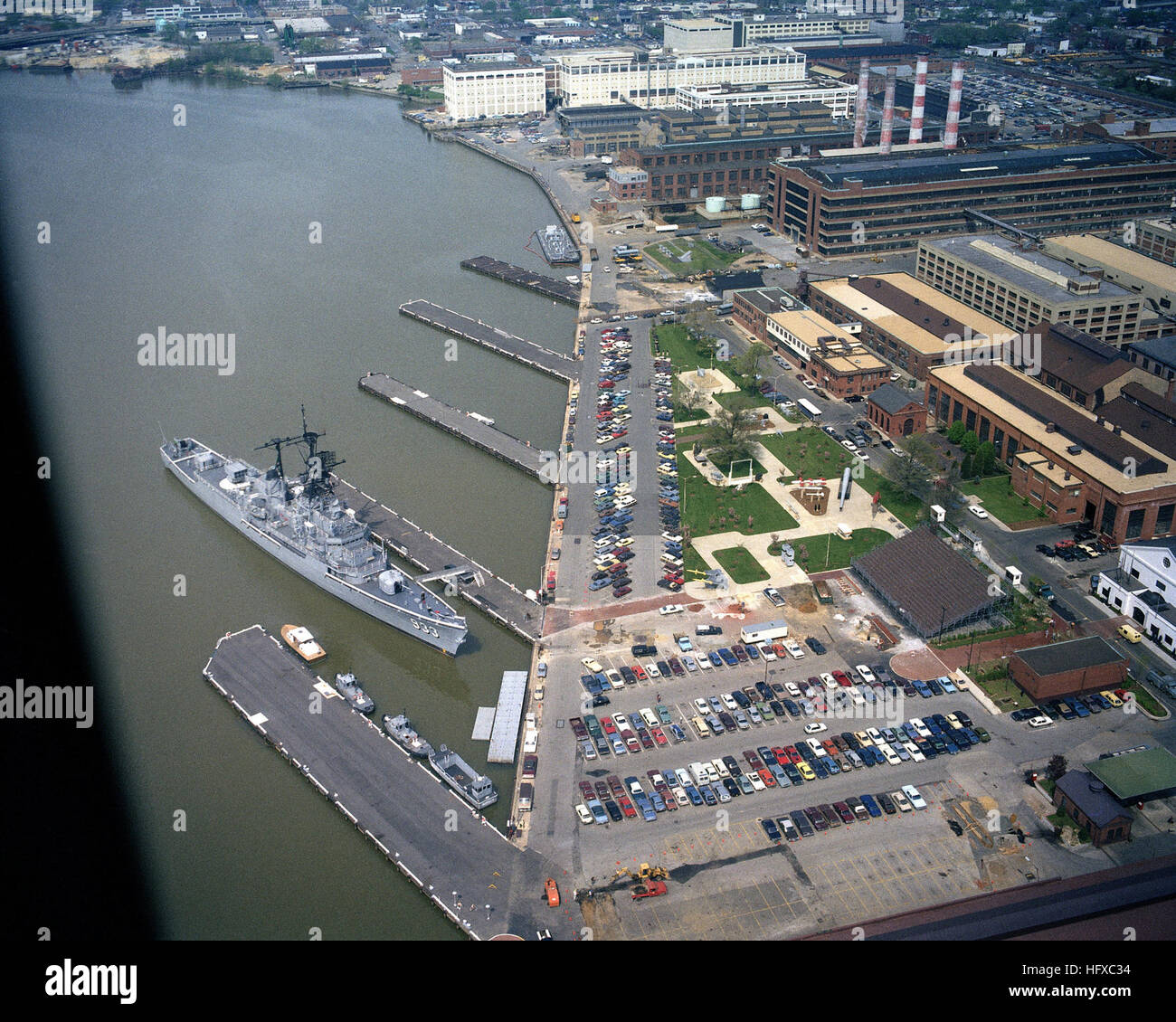 An aerial starboard view of the destroyer USS BARRY (DD 933) docked at ...