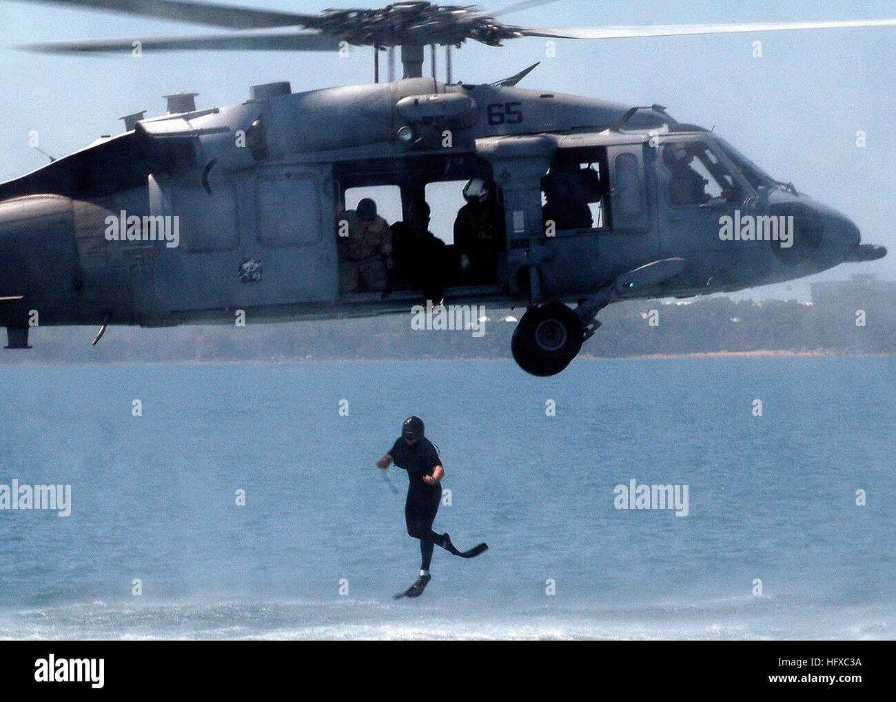 A Sailor from EODMU-3, Det. 7, jumps from an MH-60S Seahawk helicopter ...