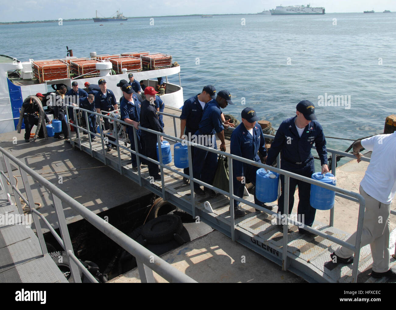 Members of the rescue and assistance team aboard the amphibious command ...