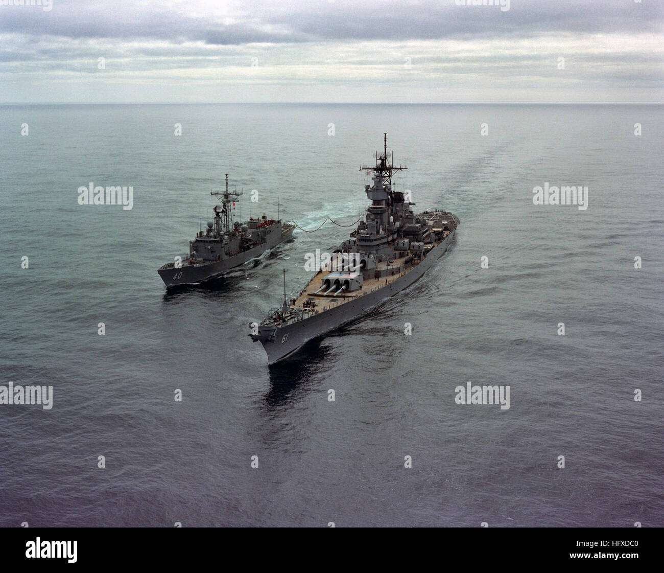 An elevated port bow view of the battleship USS IOWA (BB 61) refueling the guided missile ...