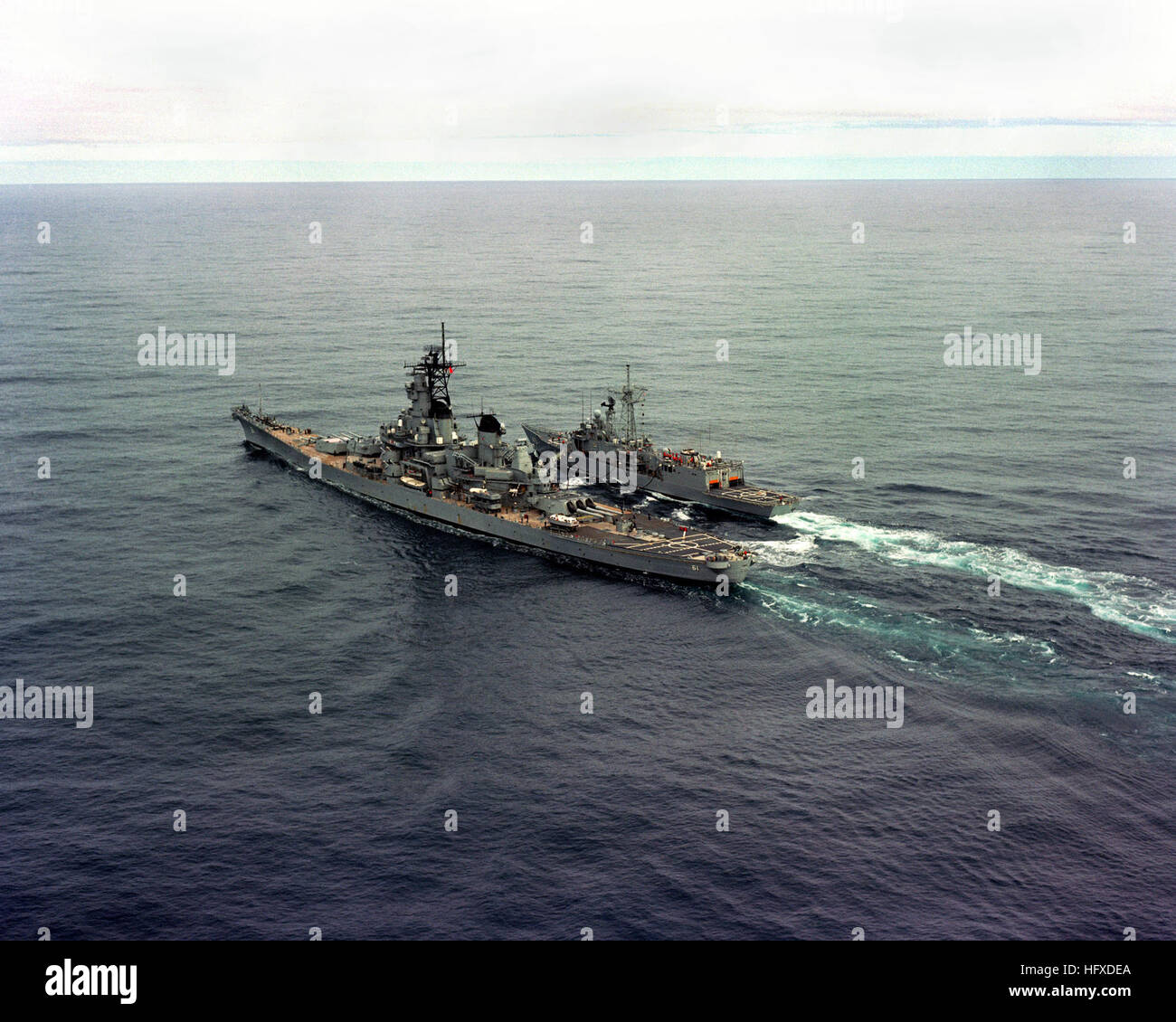 An elevated port quarter view of the battleship USS IOWA (BB 61) refueling the guided missile ...