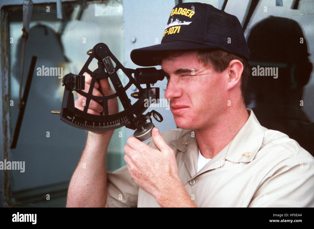 A midshipman takes a sextant reading aboard the frigate USS BADGER (FF ...
