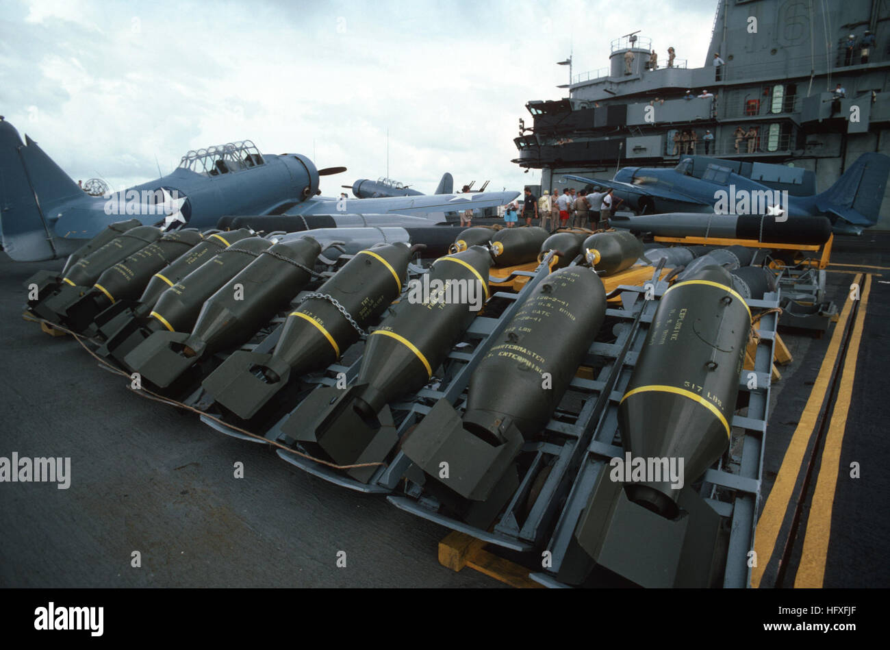 A line of World War II-era bombs are staged on the flight deck of the ...