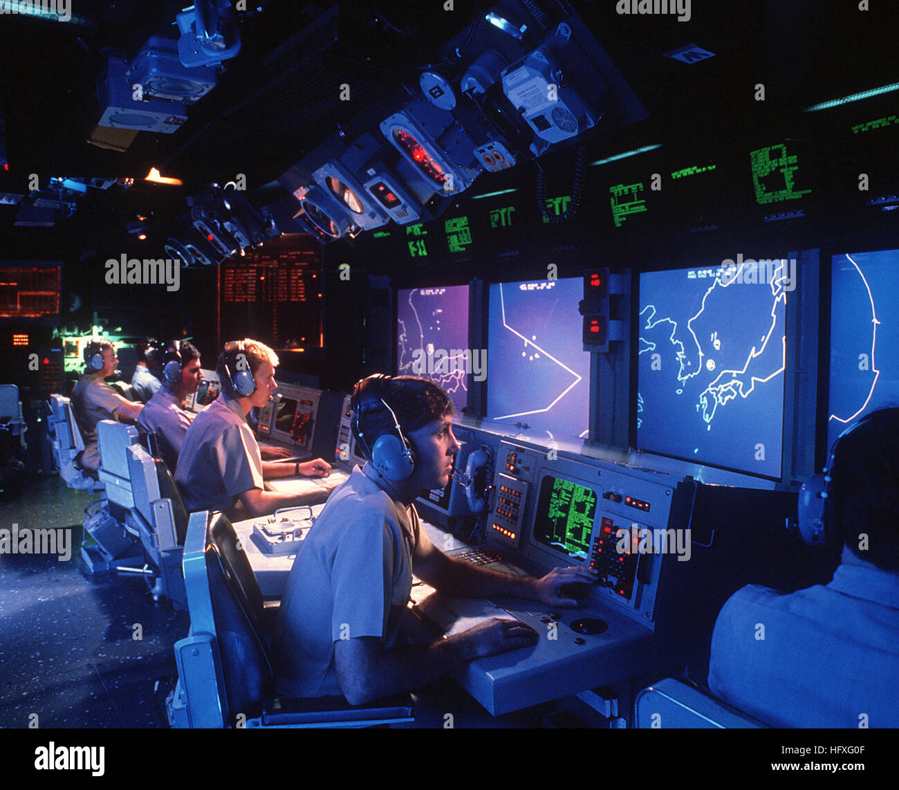 Crew members monitor radar screens in the combat information center ...