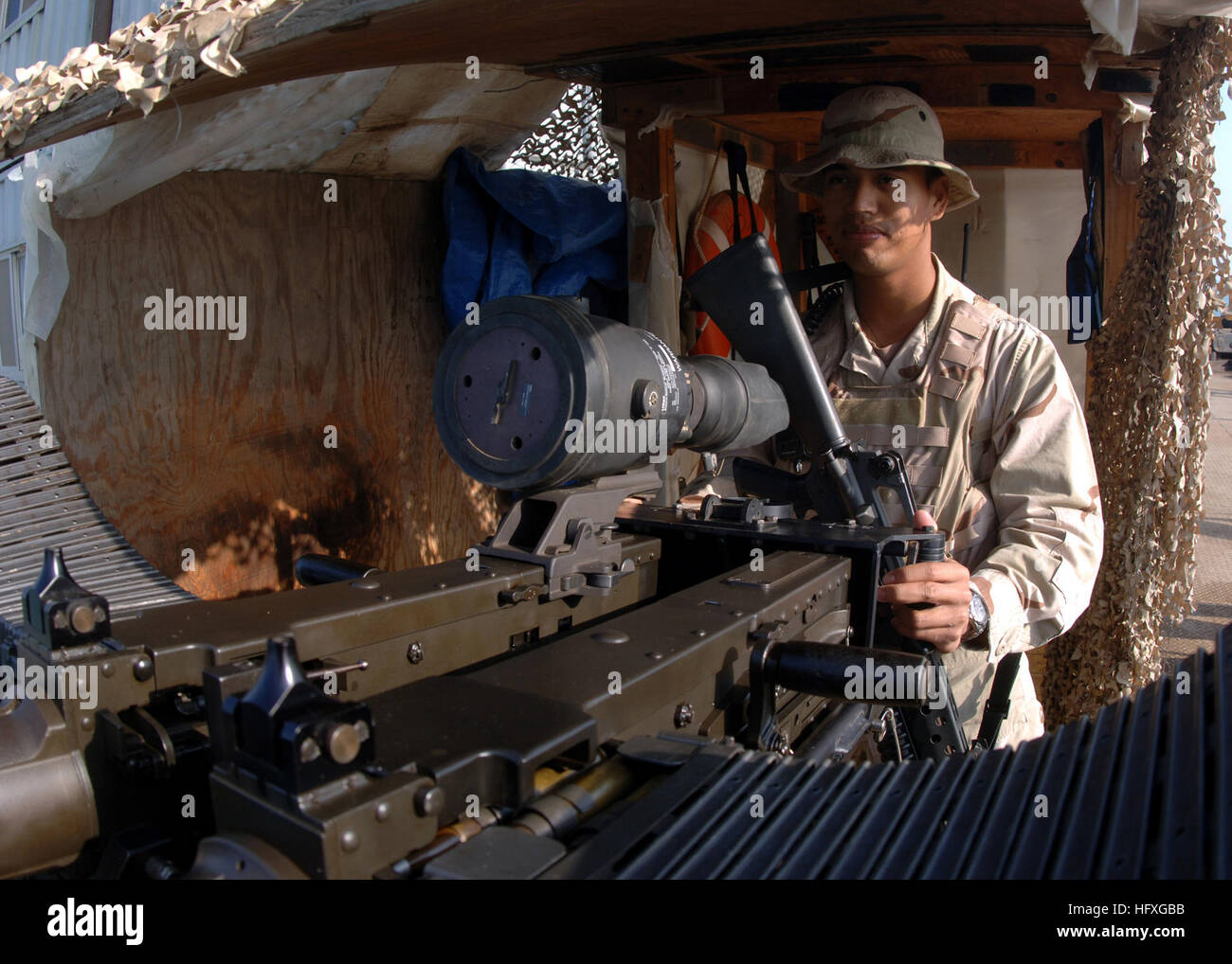 A Mobile Security Detachment (MSD-31) sailor mans a twin .50 caliber ...