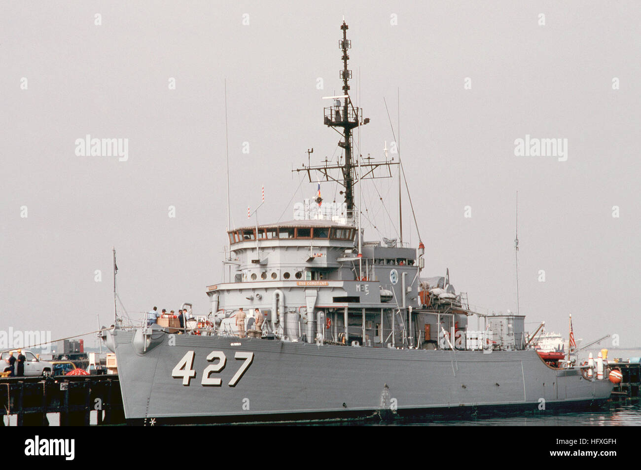 A port bow view of the ocean minesweeper USS CONSTANT (MSO 427) tied up ...