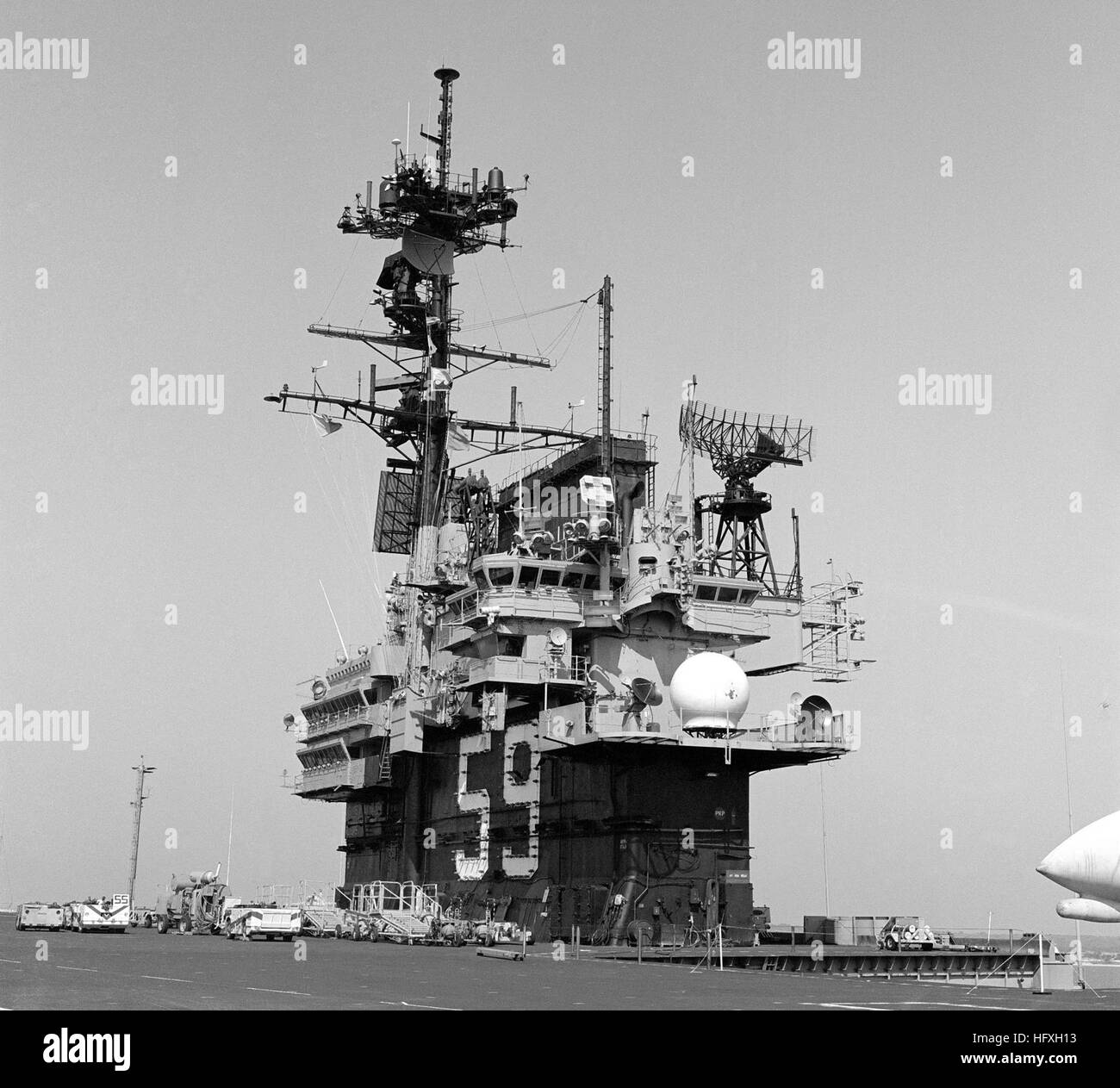 A port quarter view of the island and masts of the aircraft carrier USS ...
