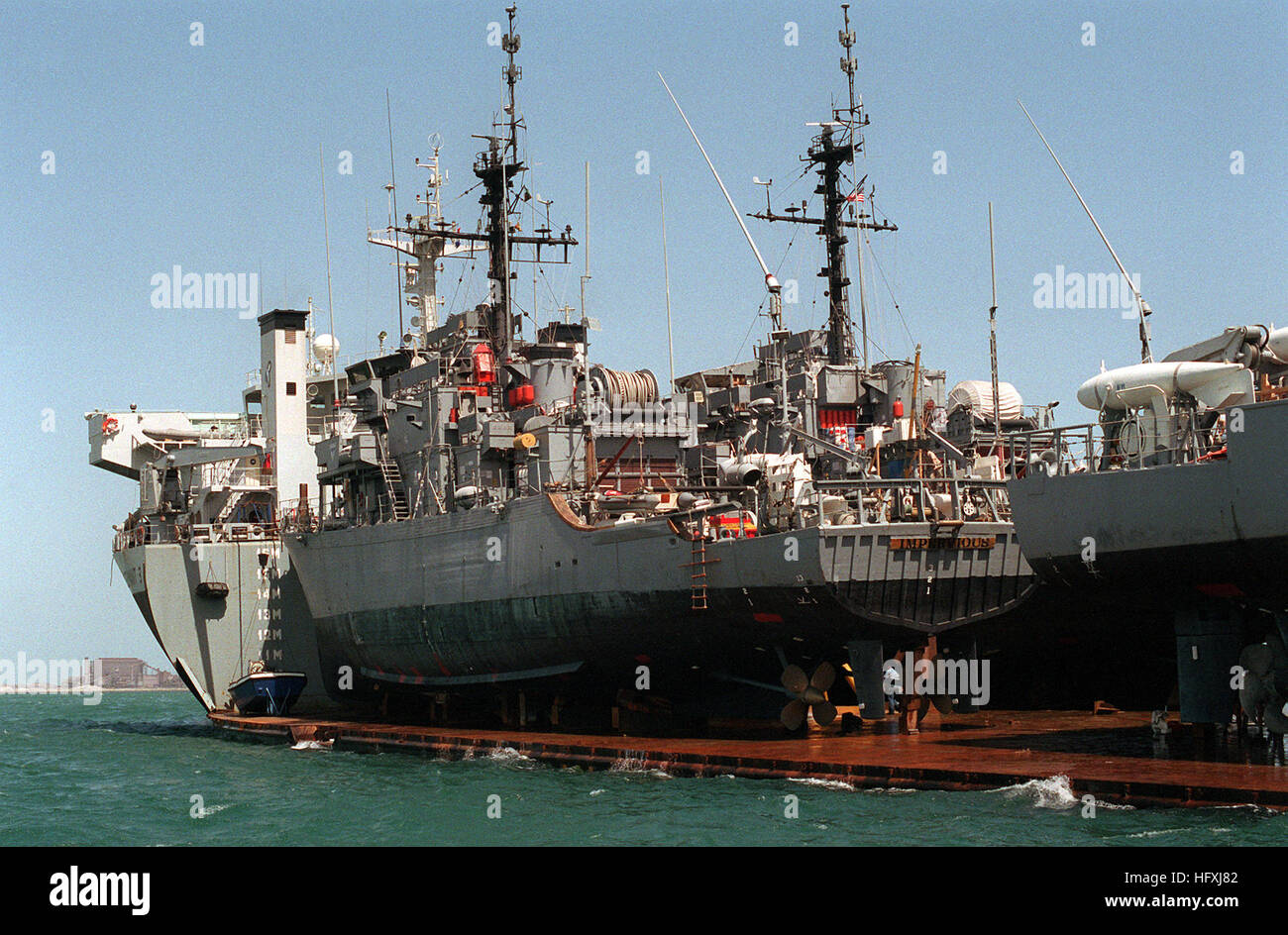 The ocean minesweeper USS IMPERVIOUS (MSO-449) and other vessels are ...