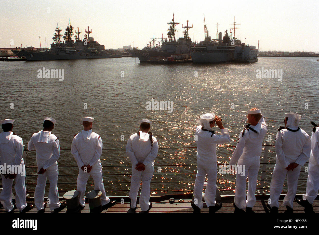 Crew members man the rails aboard the guided missile frigate USS ...