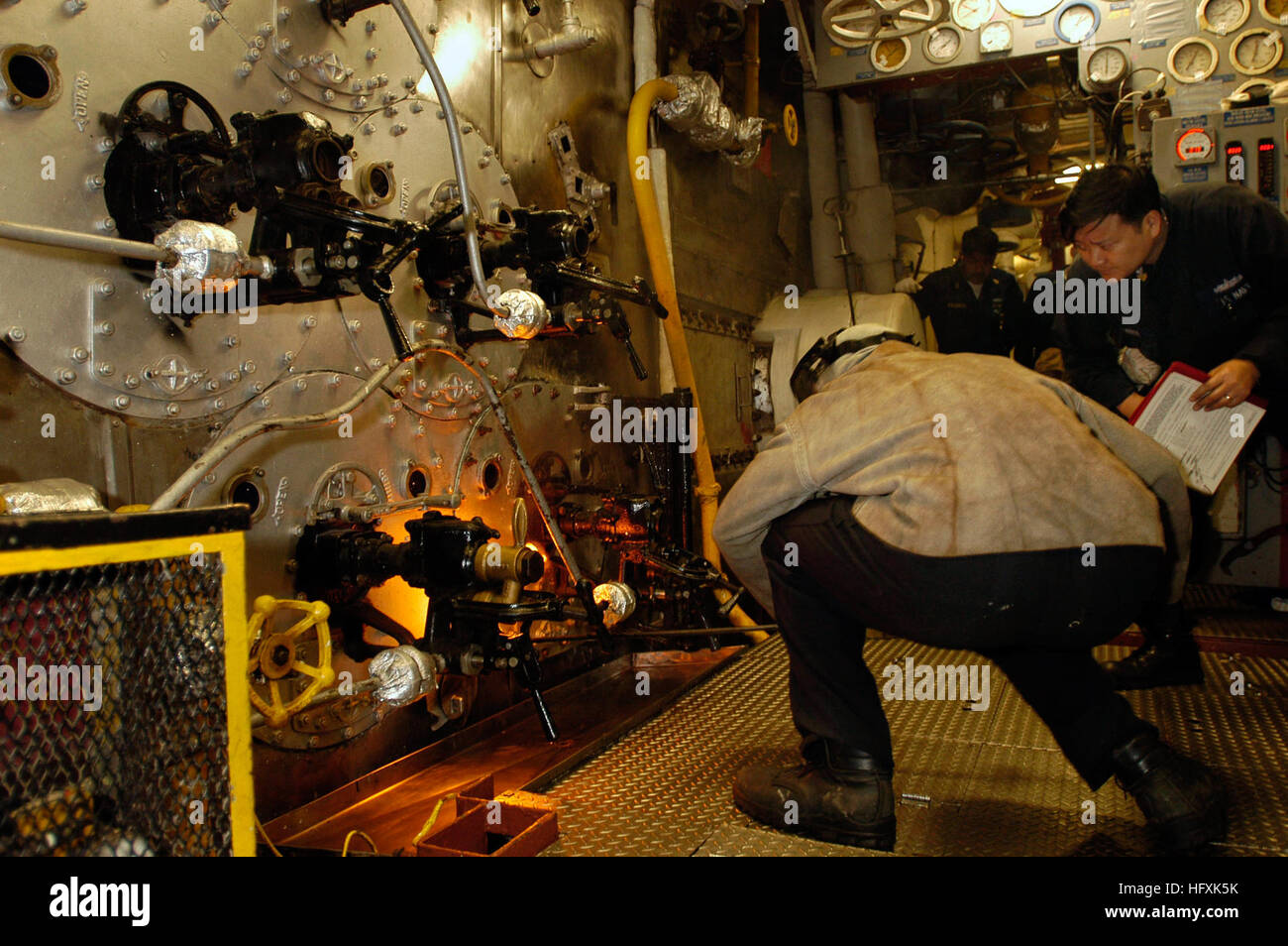 Machinist's mates aboard USS Kitty Hawk (CV 63) prepare boilers during ...