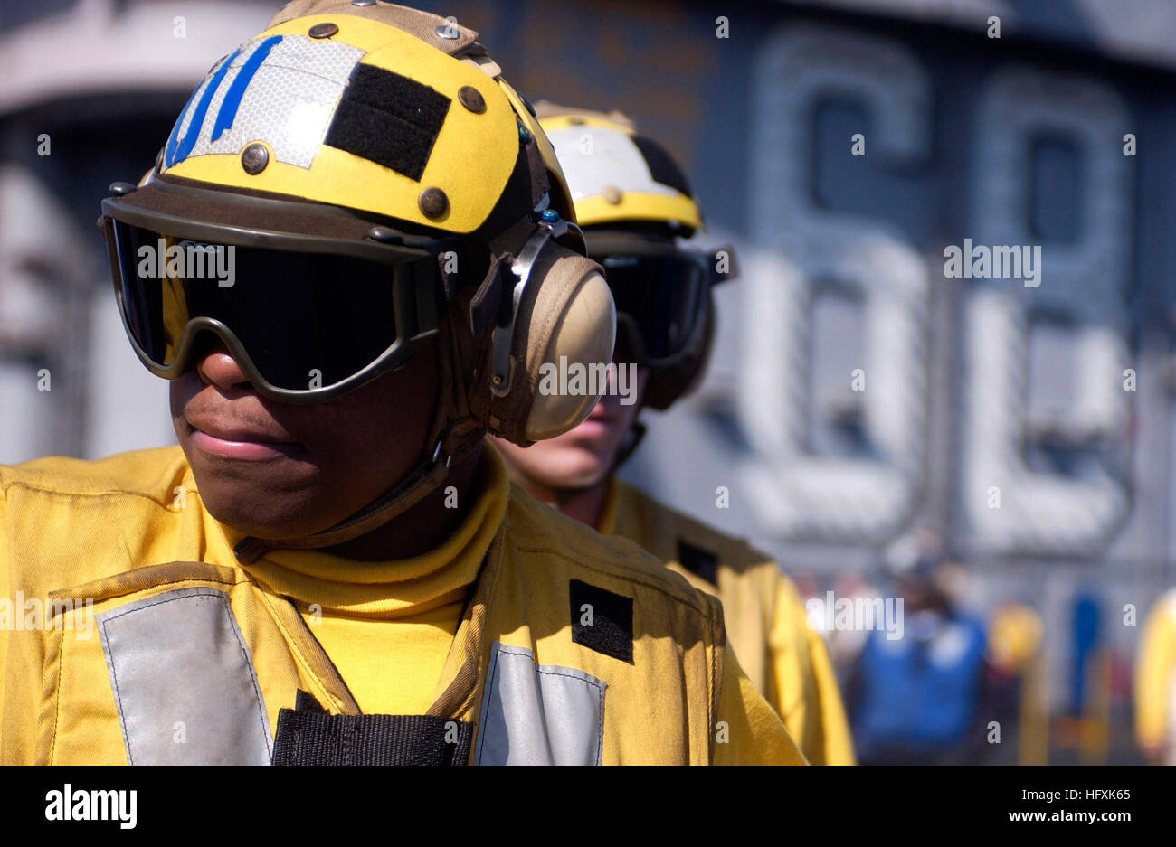 An Aviation Boatswain’s Mate directs a hose team during a flight deck ...