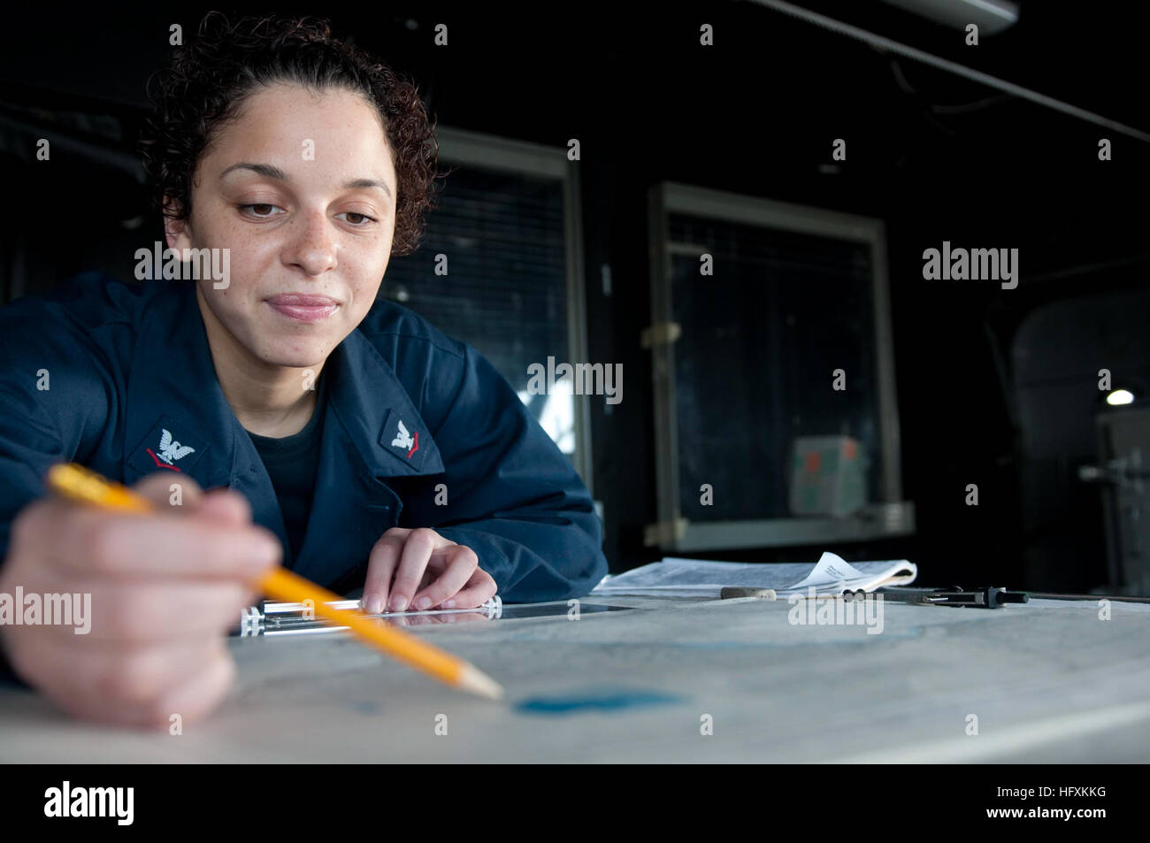 Operations Specialist plots course on flag bridge of USS Nassau (LHA 4 ...
