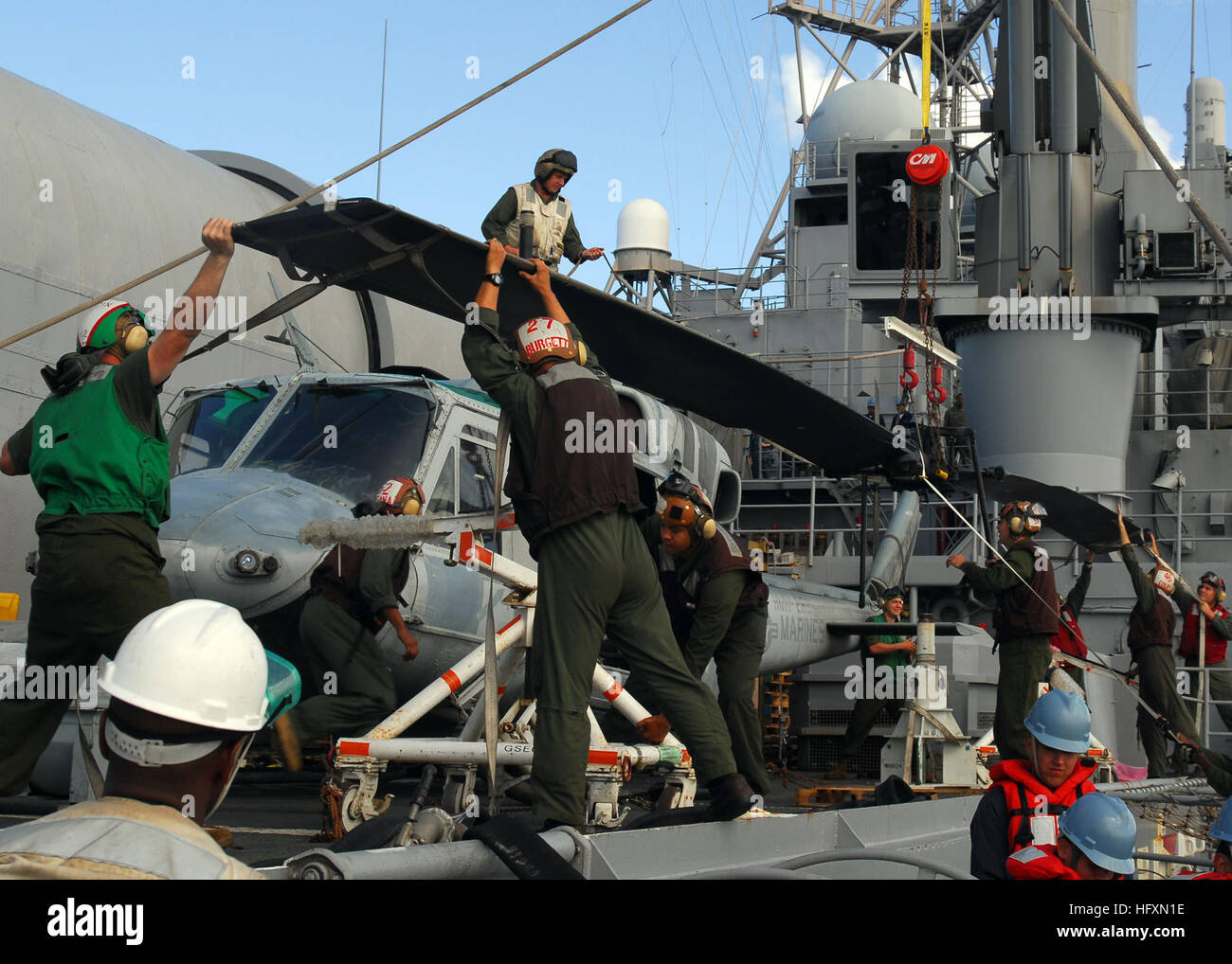 Sailors assigned to the amphibious transport dock ship USS Denver ...