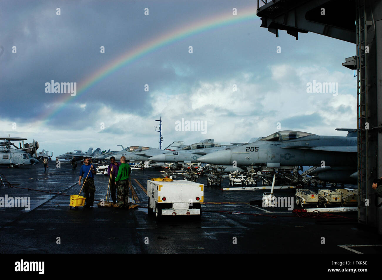 Sailors aboard aircraft carrier USS Nimitz (CVN 68) clean the flight ...