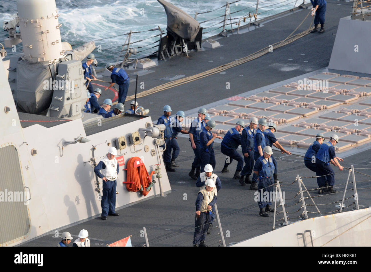 Sailors aboard the Arleigh Burke-class Destroyer USS Gridley heave in a ...