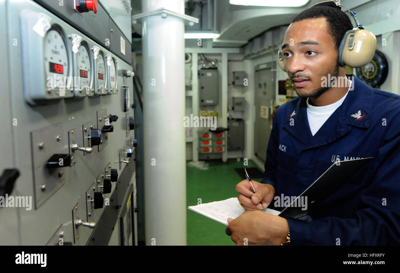 An Engineman 3rd Class aboard USS Blue Ridge (LCC 19) takes switchboard ...