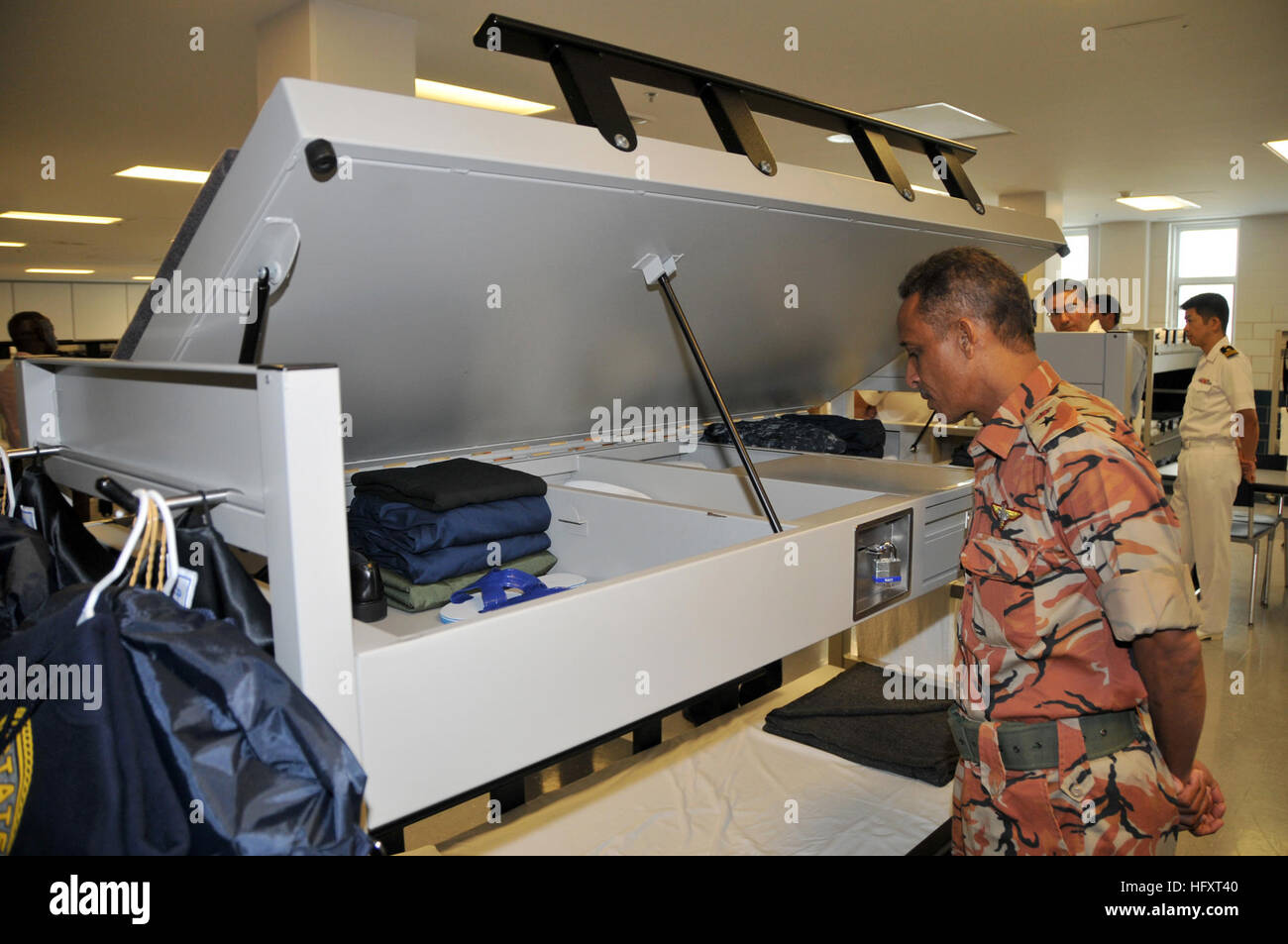 A foreign naval attaché from the Sultan's Armed Forces of Oman inspects ...