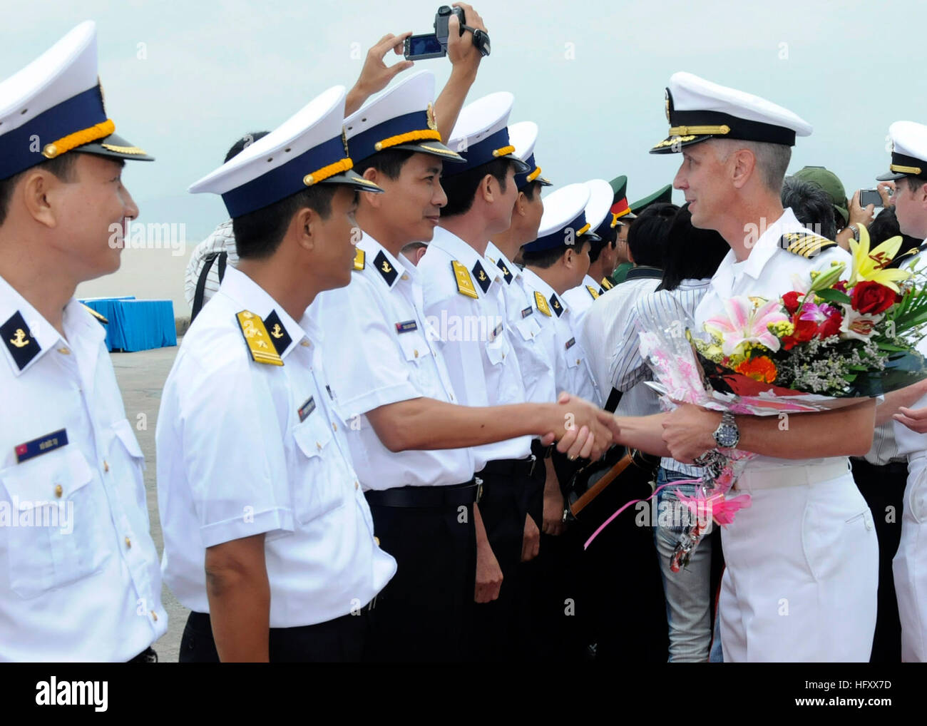 Vietnamese naval officers greet Capt. Thom W. Burke, commanding officer ...