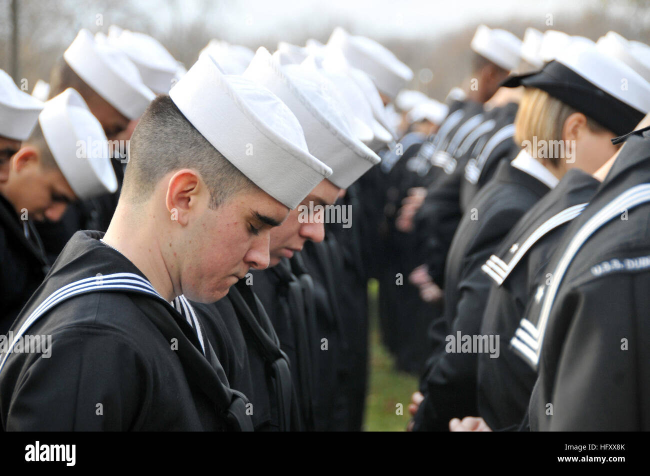 U.S. Sailors with the Naval Hospital Corps School bow their heads for a ...