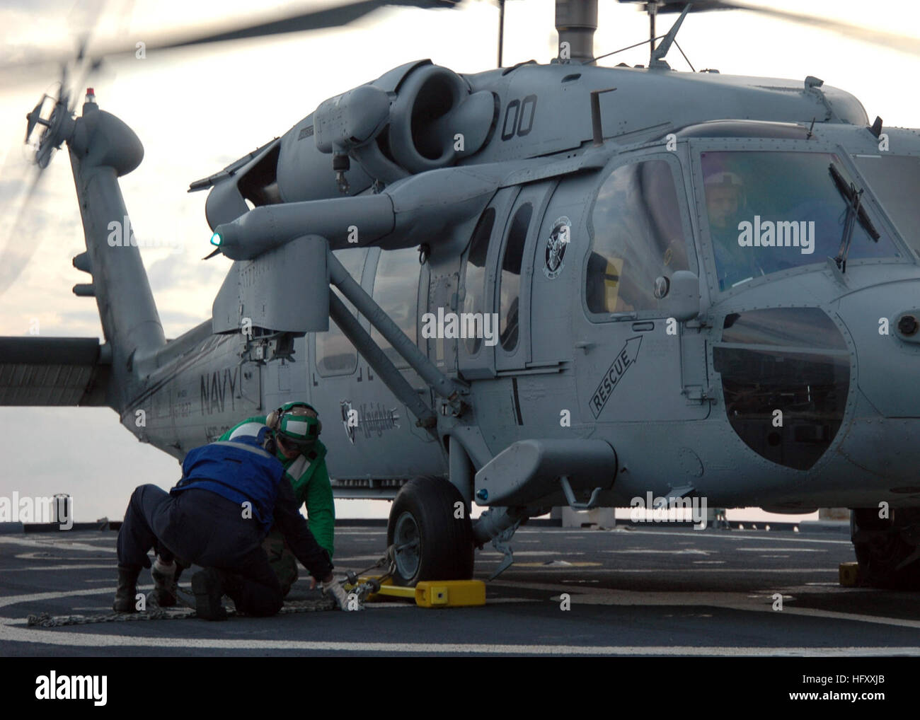 Flight-deck crew on USS Freedom (LCS 1) secure an MH-60S Sea Hawk ...