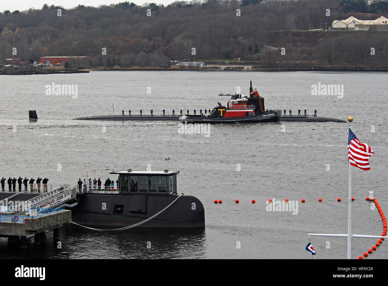 Sailors aboard the nuclear submarine Nautilus salute the Sailors aboard ...