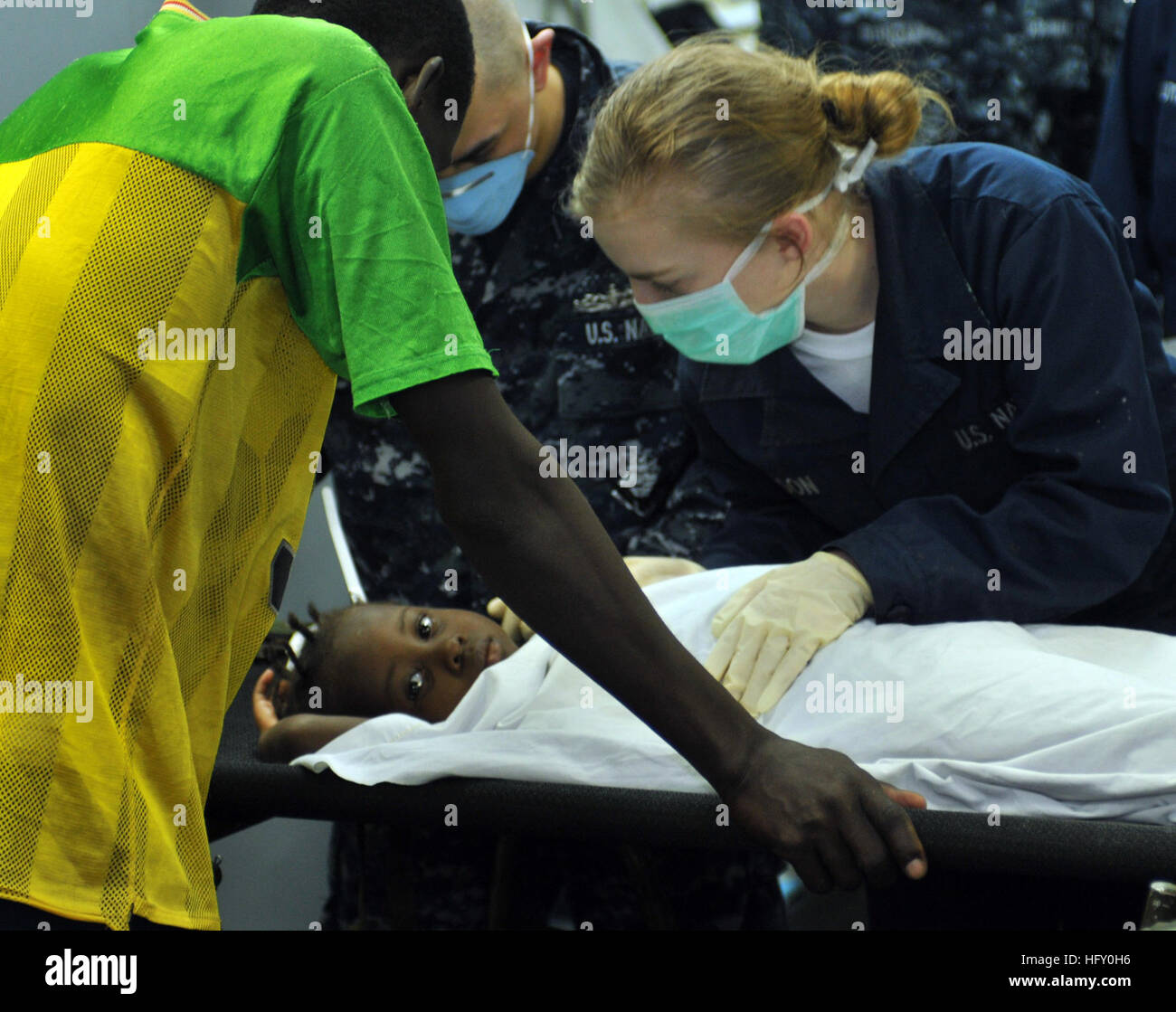 Medical personnel aboard USS Bataan (LHD 5) treat injured patients ...
