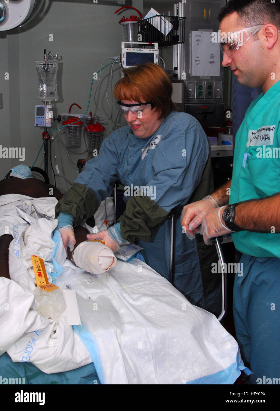 Medical personnel dress an amputee patient aboard USNS Comfort (T-AH 20 ...