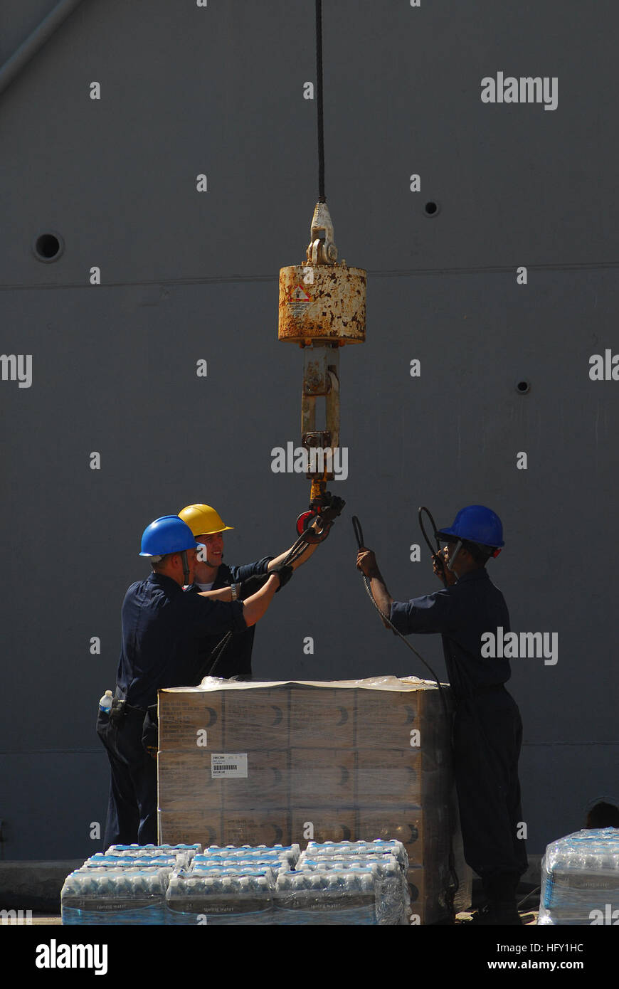 Seabees from NCHB 1 and 13 load humanitarian supplies onto USS Ashland ...