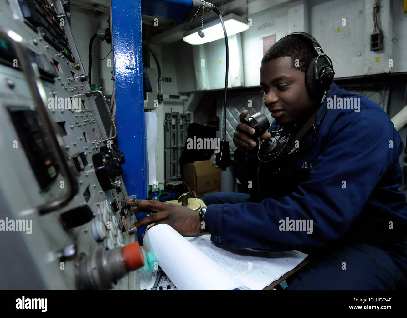 Mark Jean, a fire controlman fireman, pushes the fire button on the ...