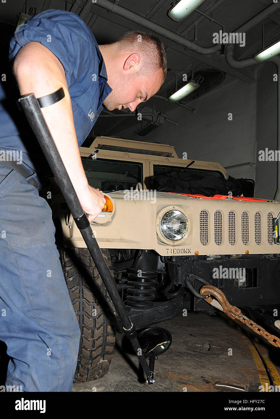 Seaman uses a mirror to perform a mock vehicle inspection during anti ...
