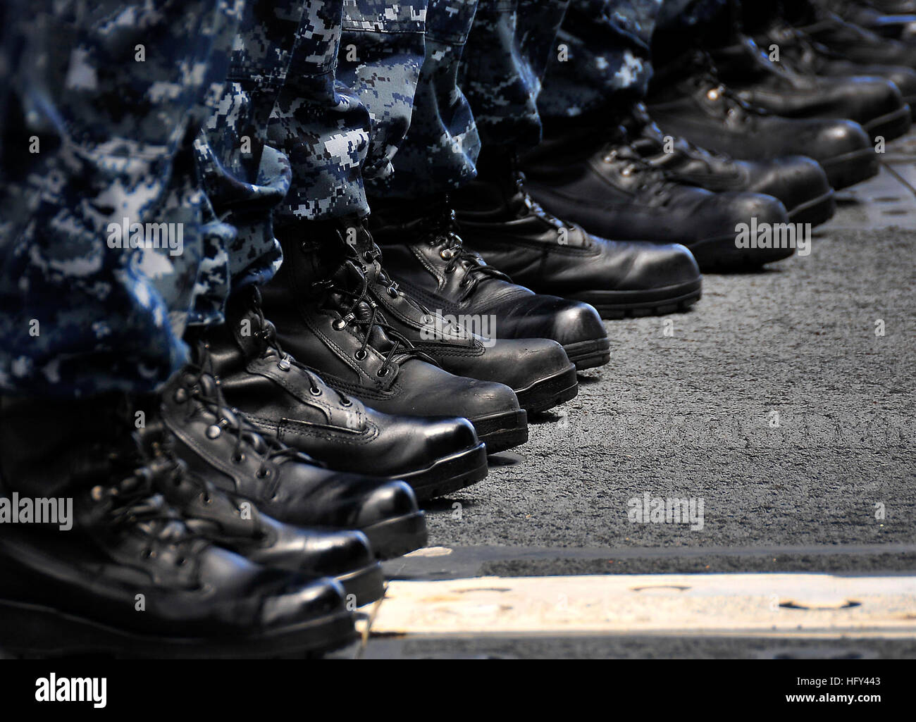 Sailors aboard USS Bunker Hill (CG 52) stand at attention during an ...