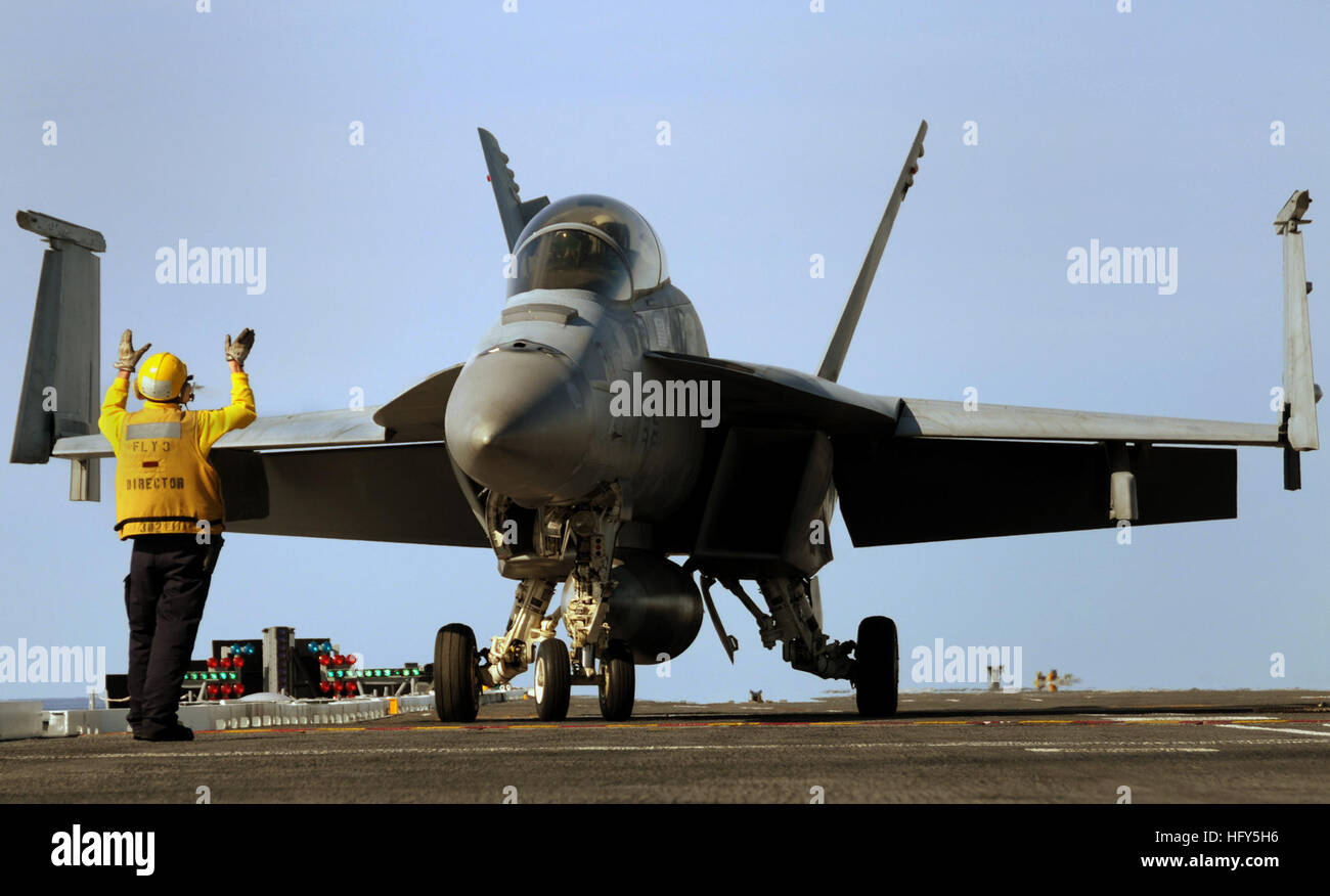 A Sailor aboard aircraft carrier USS George H.W. Bush (CVN 77) directs ...