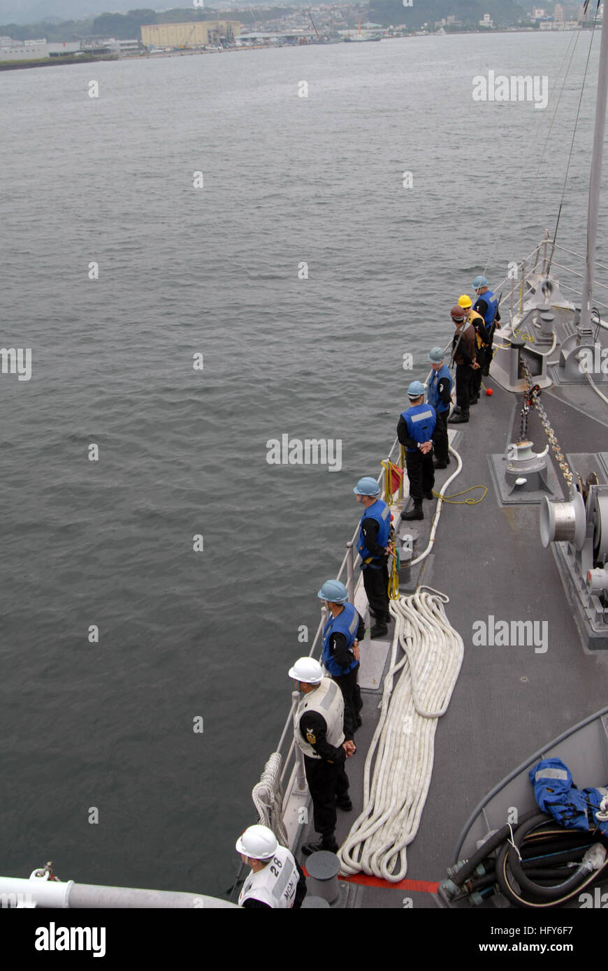 Line handlers aboard mine countermeasures ship USS Patriot man the ...