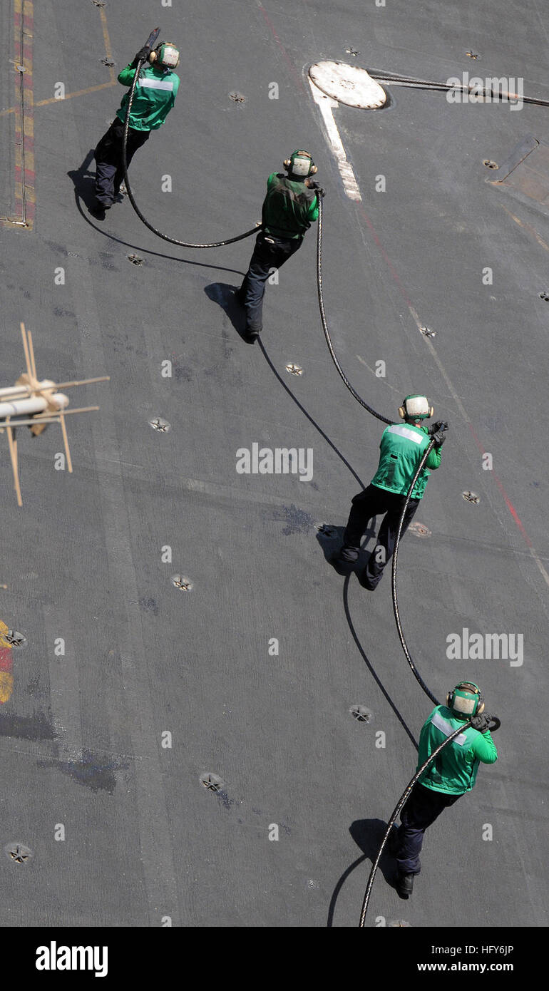 100512-N-4236E-160 ARABIAN SEA (May 12, 2010) Sailors carry an ...