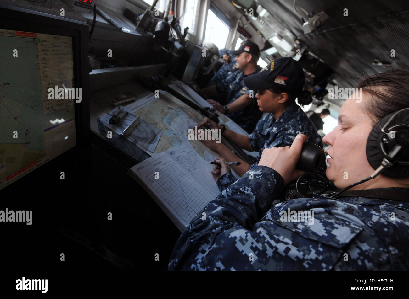 Petty Officer 3rd Class Lorena Guzman records the bearings of the ...