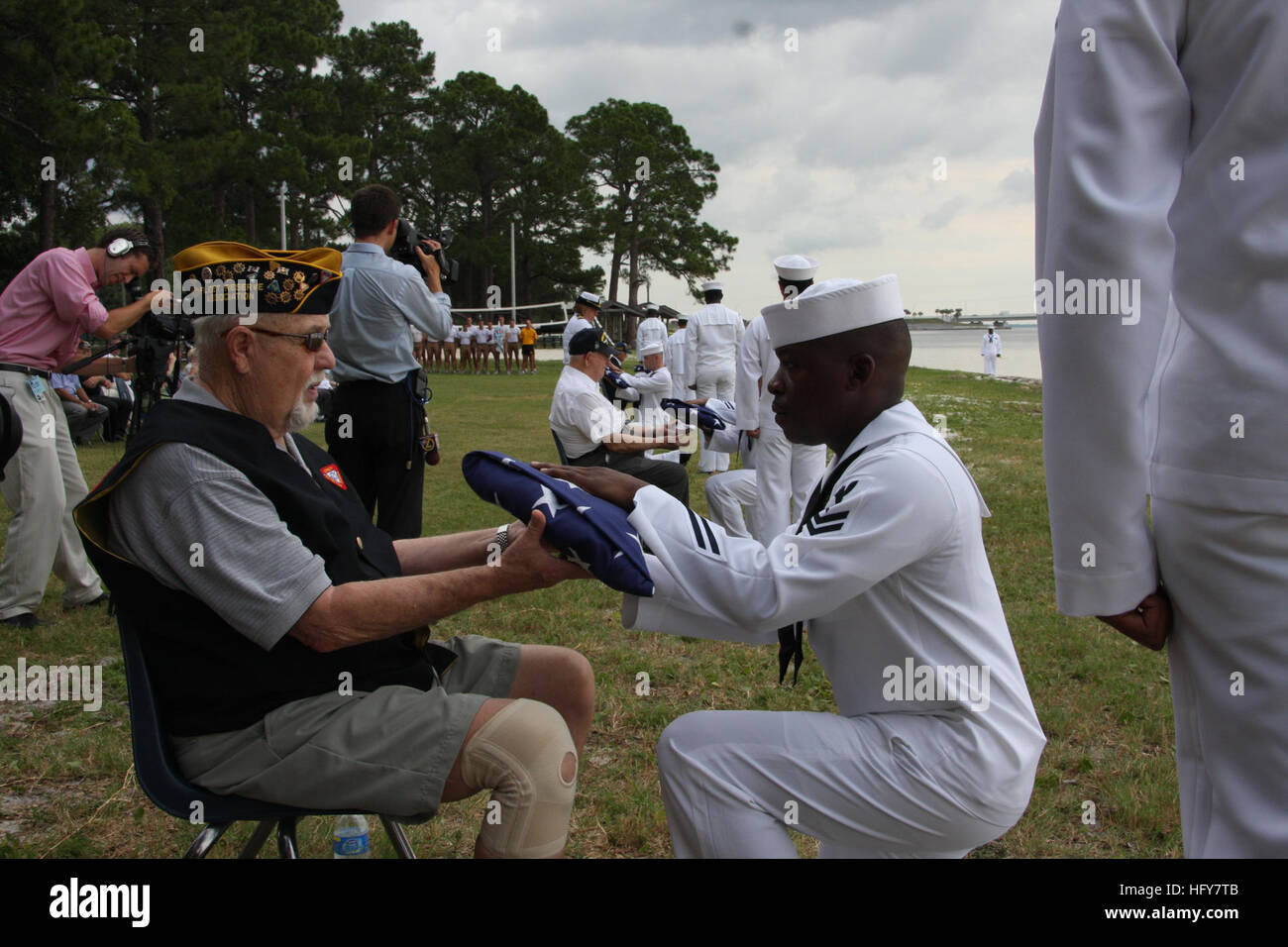 Logistics personnel present American flags during a Battle of Midway ...