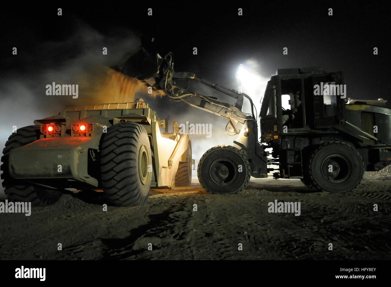A Seabee from Naval Mobile Construction Battalion (NMCB) 5 operates a ...