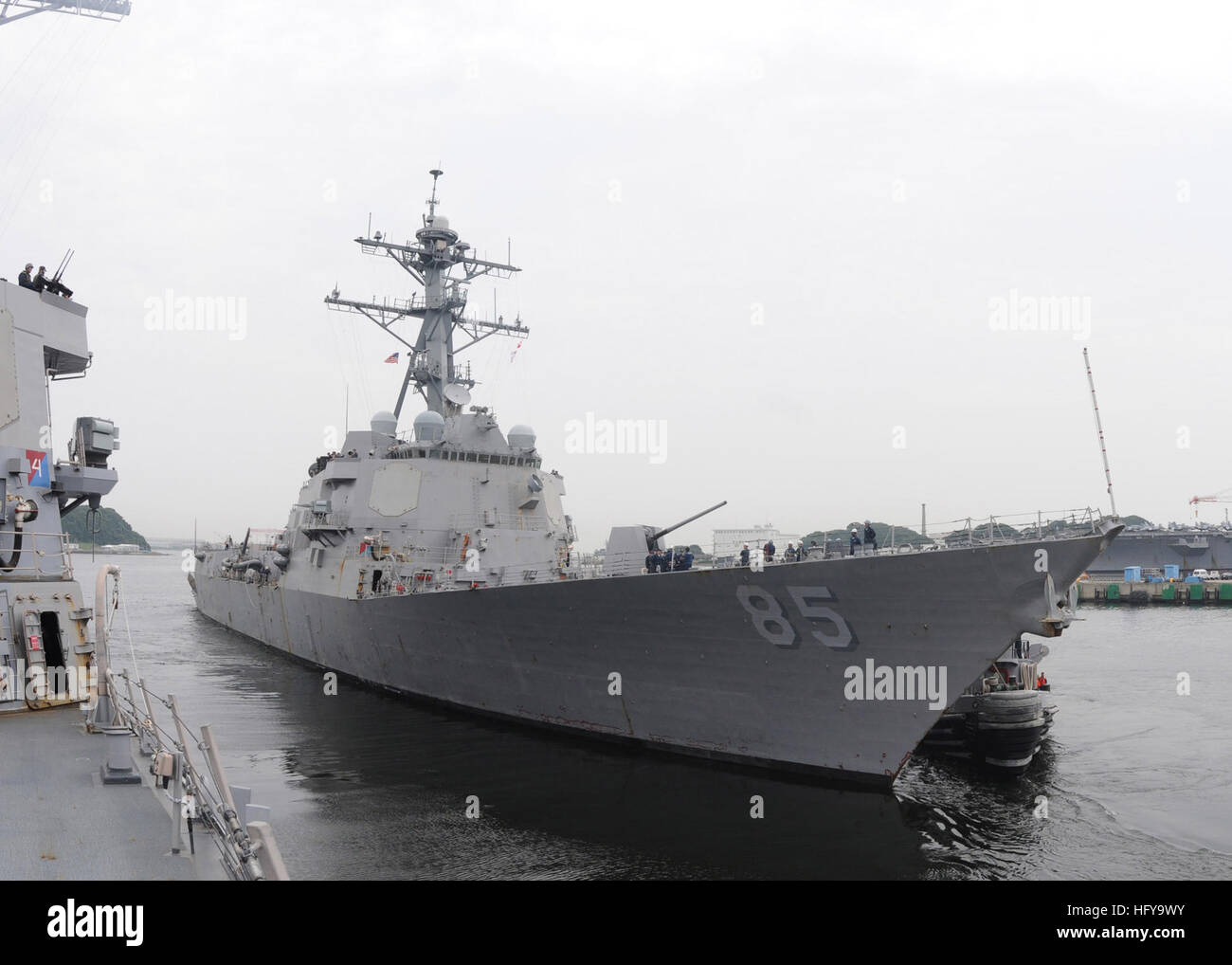 A tug boat assists Arleigh Burke-class destroyer USS McCampbell get ...