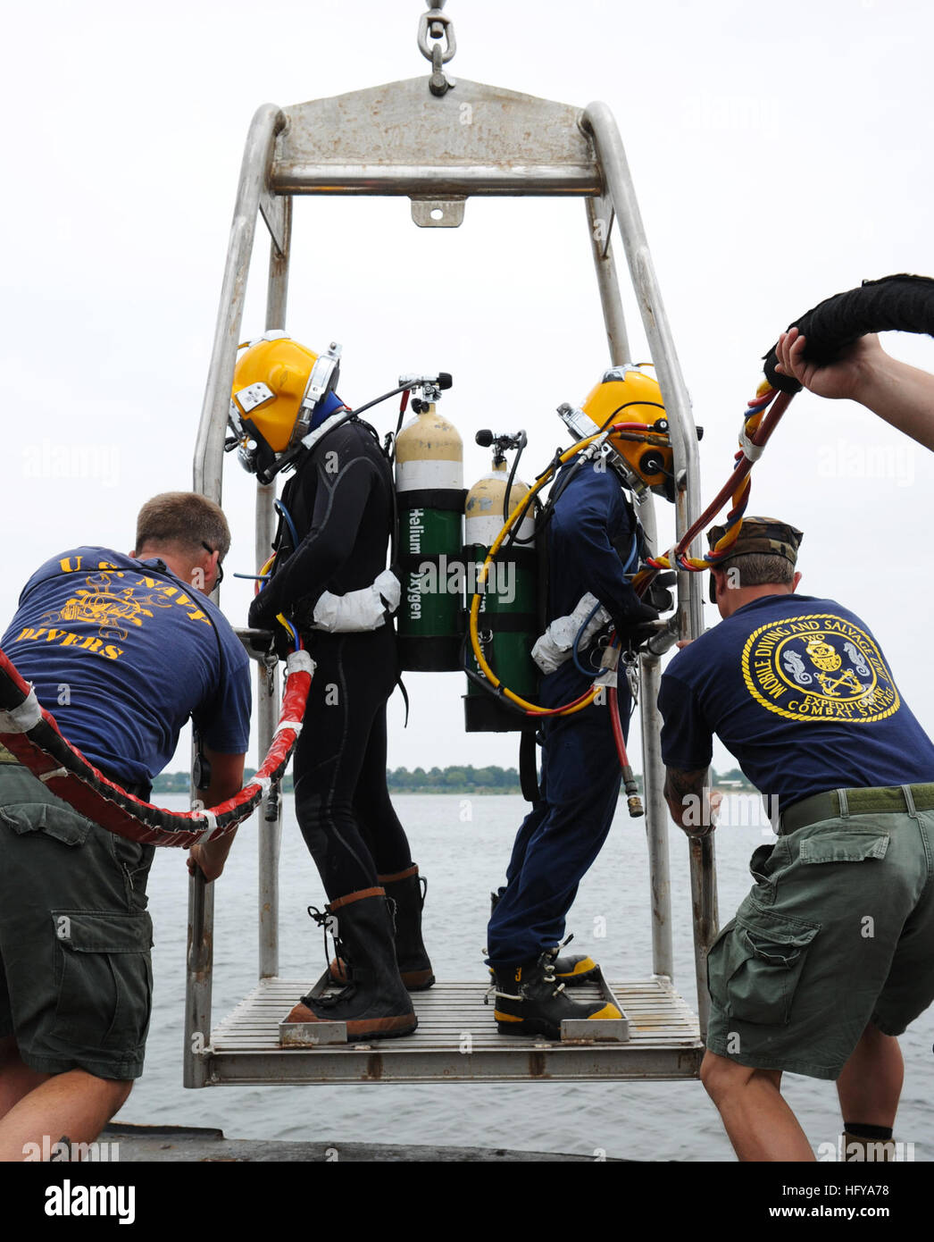 Navy divers from MDSU-2 are lowered from USNS Apache (T-ATF 172) to ...