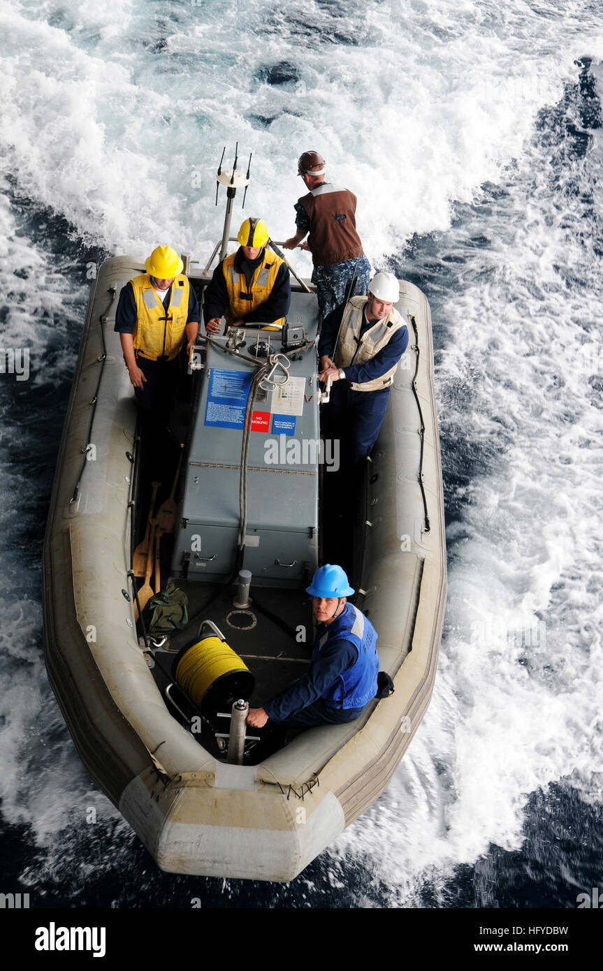 Boatswain’s Mate pilots a rigid-hull inflatable boat alongside aircraft ...