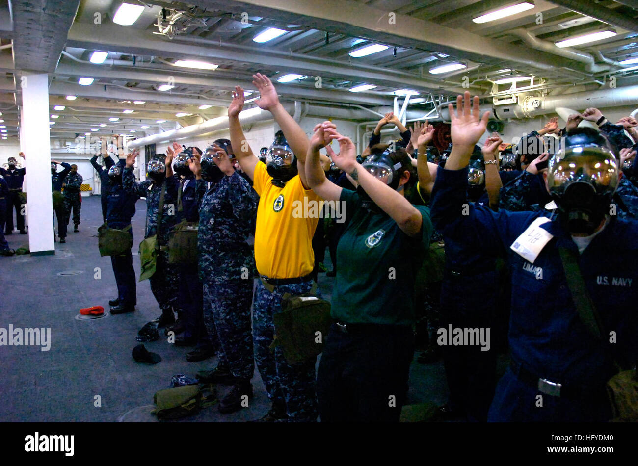 Sailors raise their arms, signifying that they have successfully donned ...