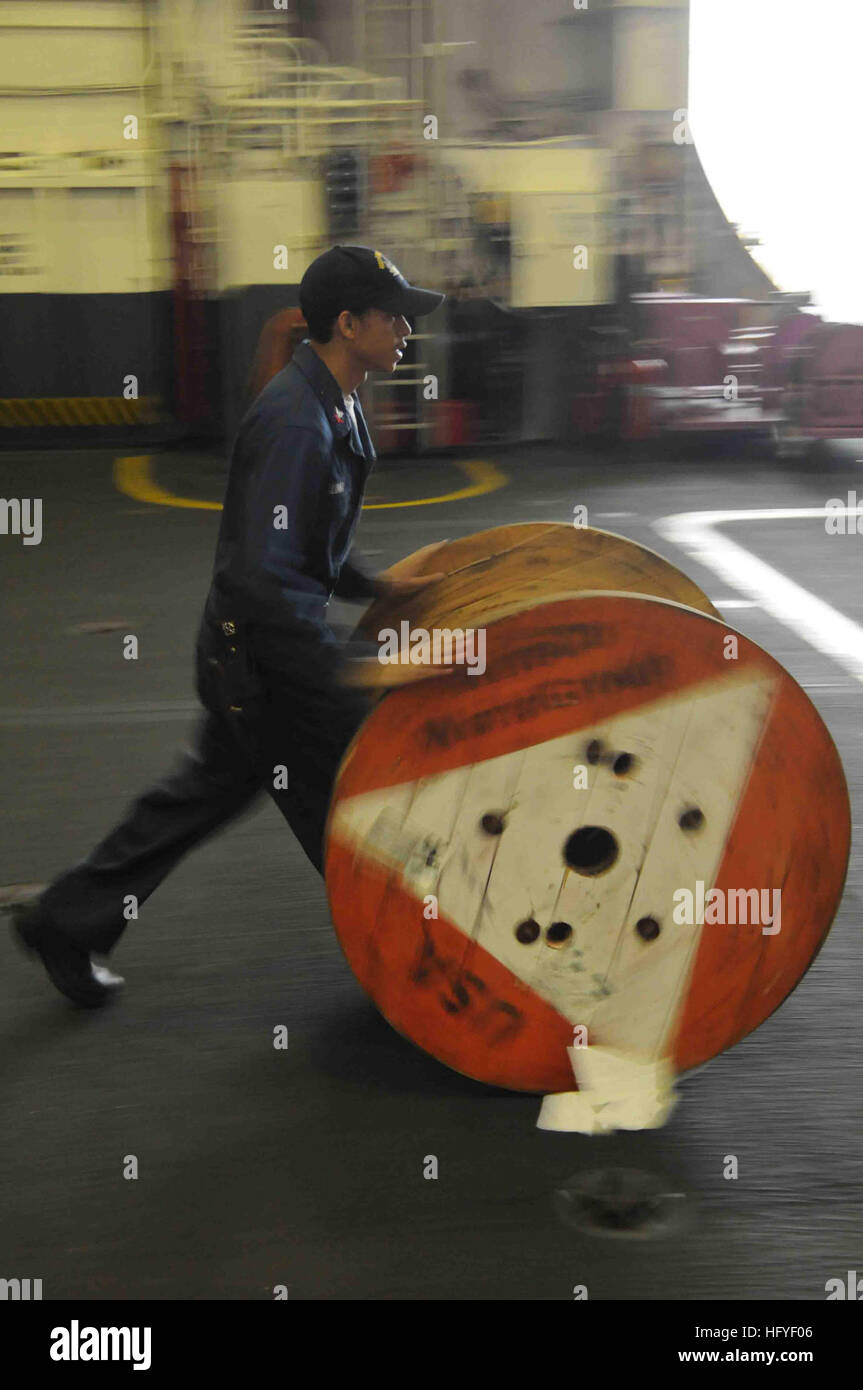Petty Officer 2nd Class Alexander Luna transports a spool during an ...