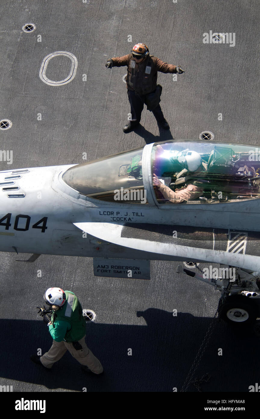 A plane captain from Strike Fighter Squadron VFA-25 guides F/A-18C ...