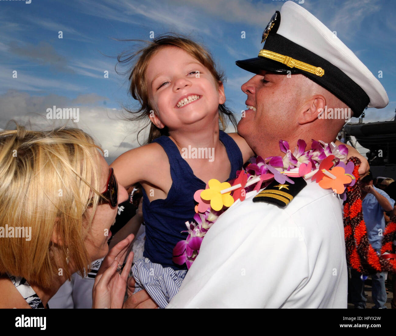 Family members greet sailors returning to the guided-missile destroyer ...