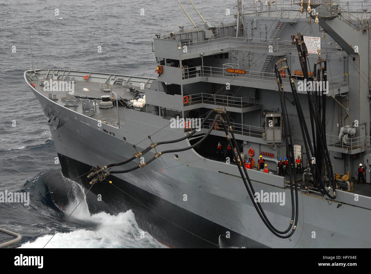 Fuel lines are transferred from USNS Bridge (T-AOE 10) to USS Ronald ...