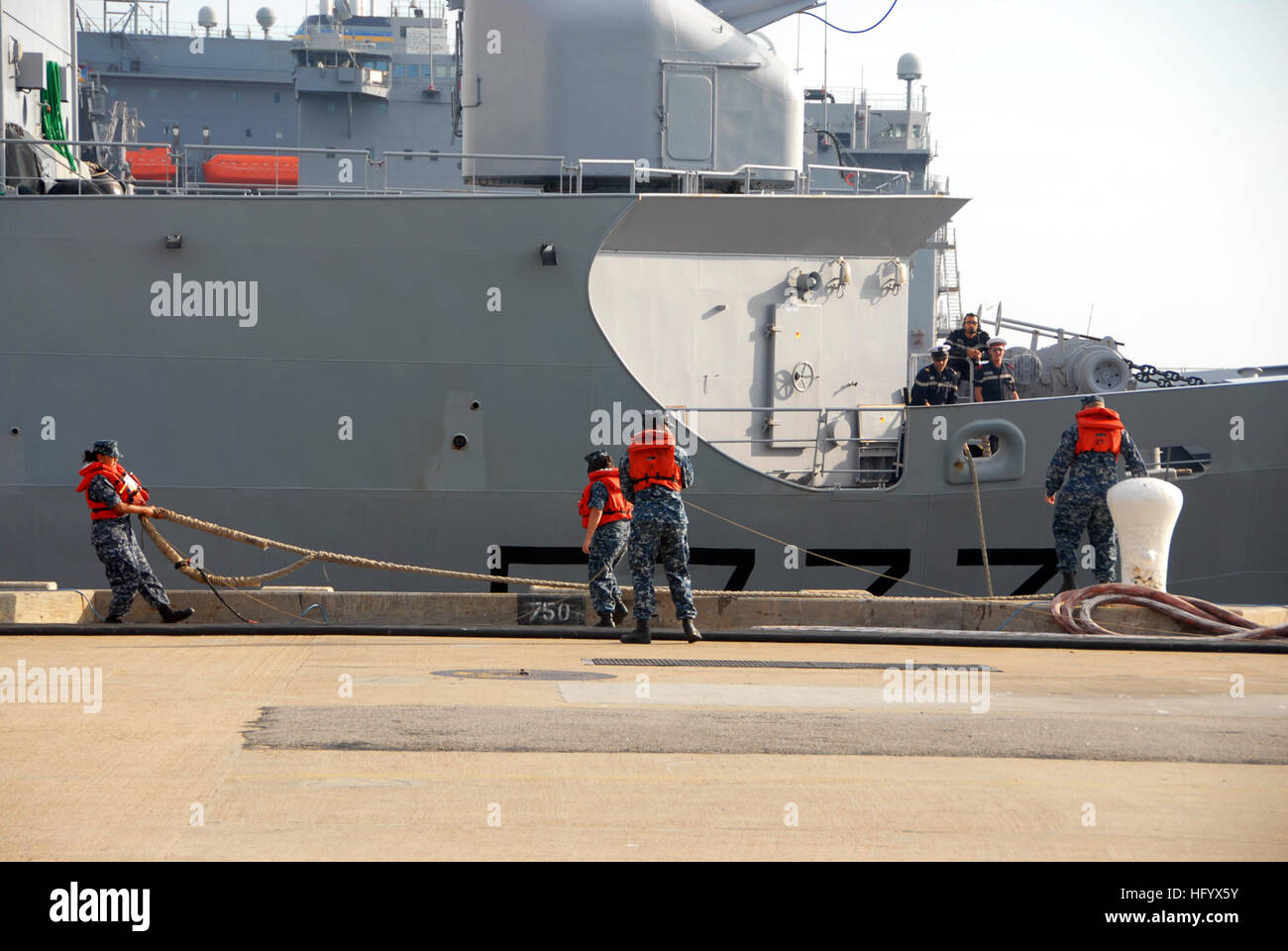 Sailors assigned to the guided-missile destroyer USS Ross handle ...