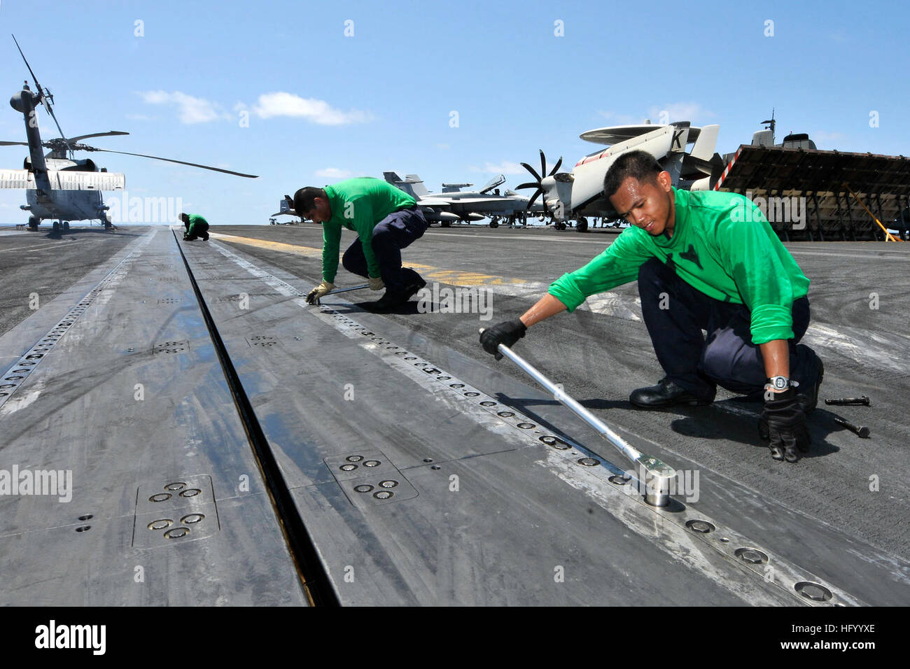 An Aviation Boatswain's Mate (Equipment) uses a torque wrench to ...